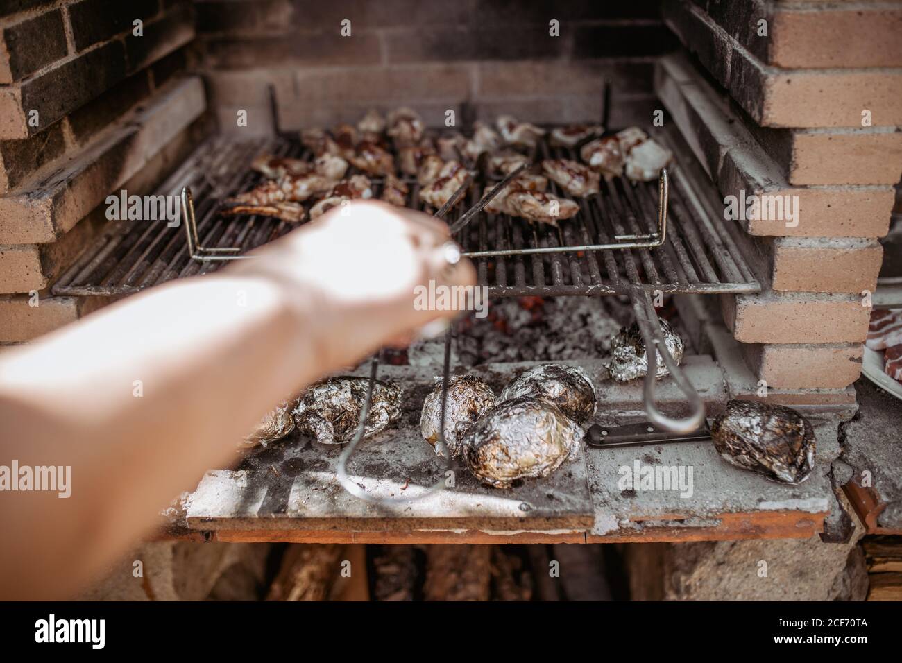 crop person cooking meat in barbecue Stock Photo - Alamy