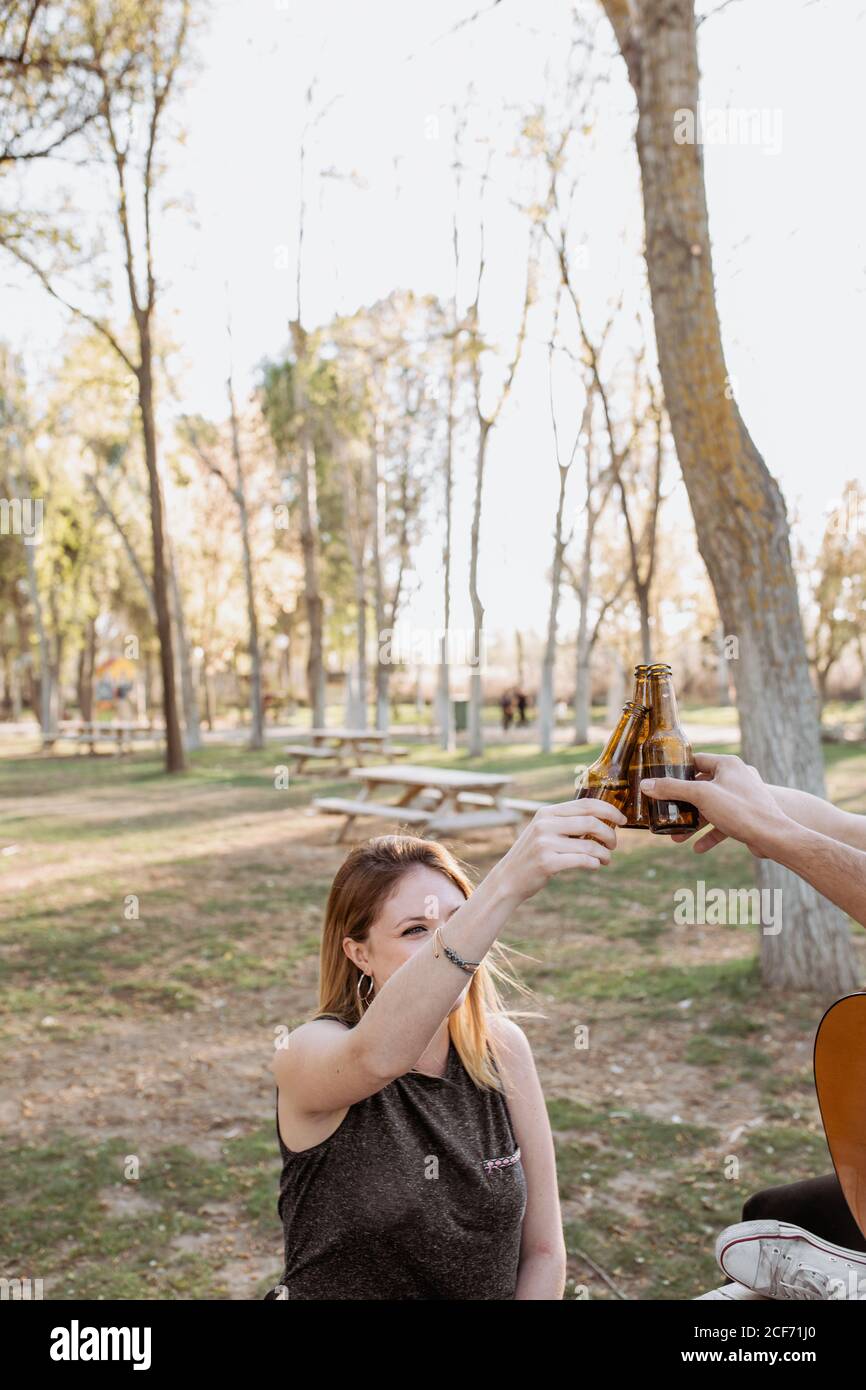 Young musicians drinking beer in park Stock Photo - Alamy