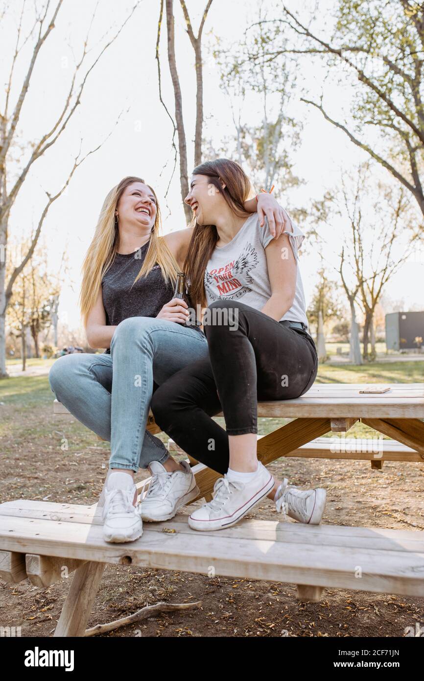 girl friends hugging and laughing in park Stock Photo - Alamy