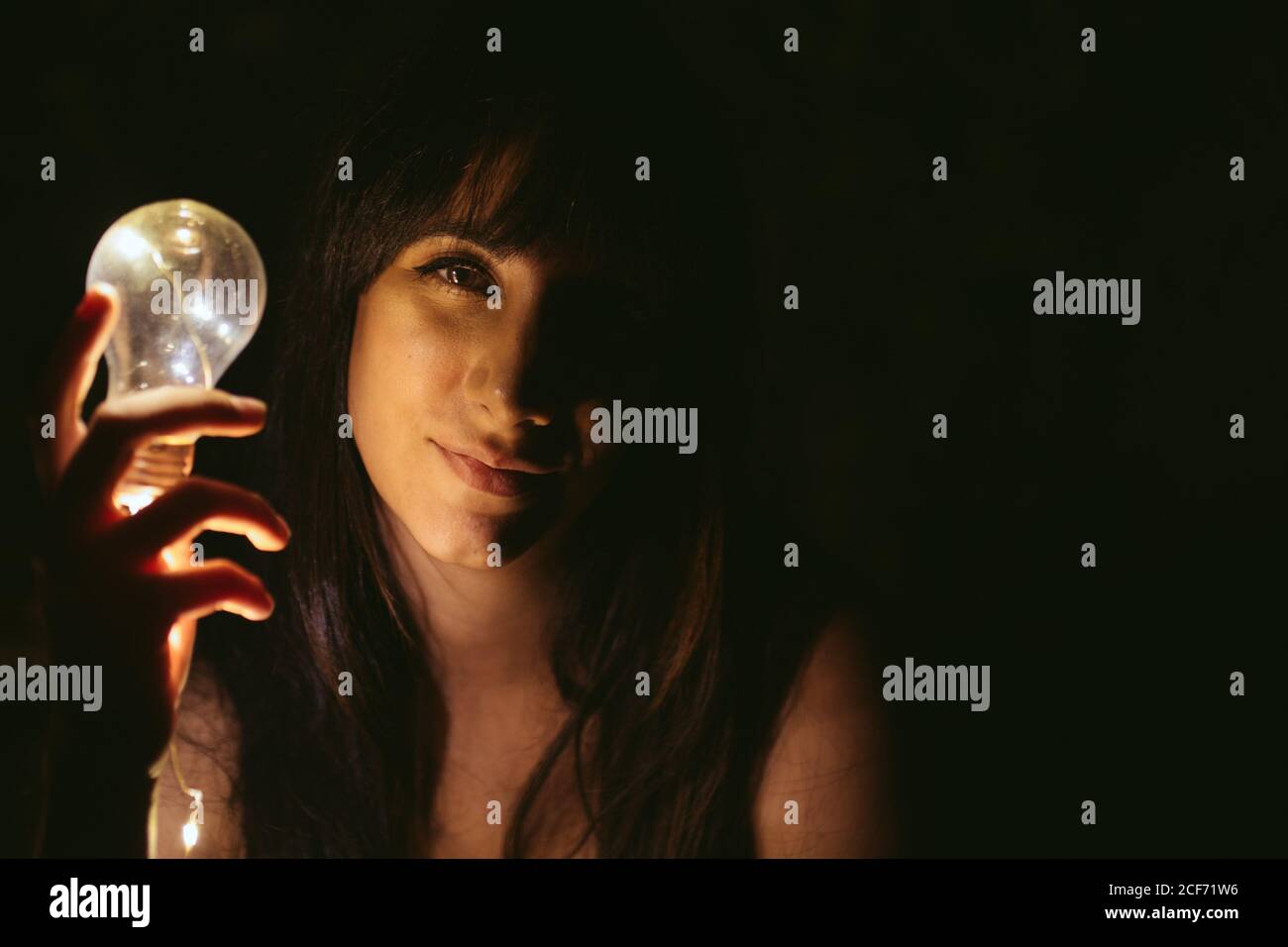 Woman and lightbulb hi-res stock photography and images - Alamy