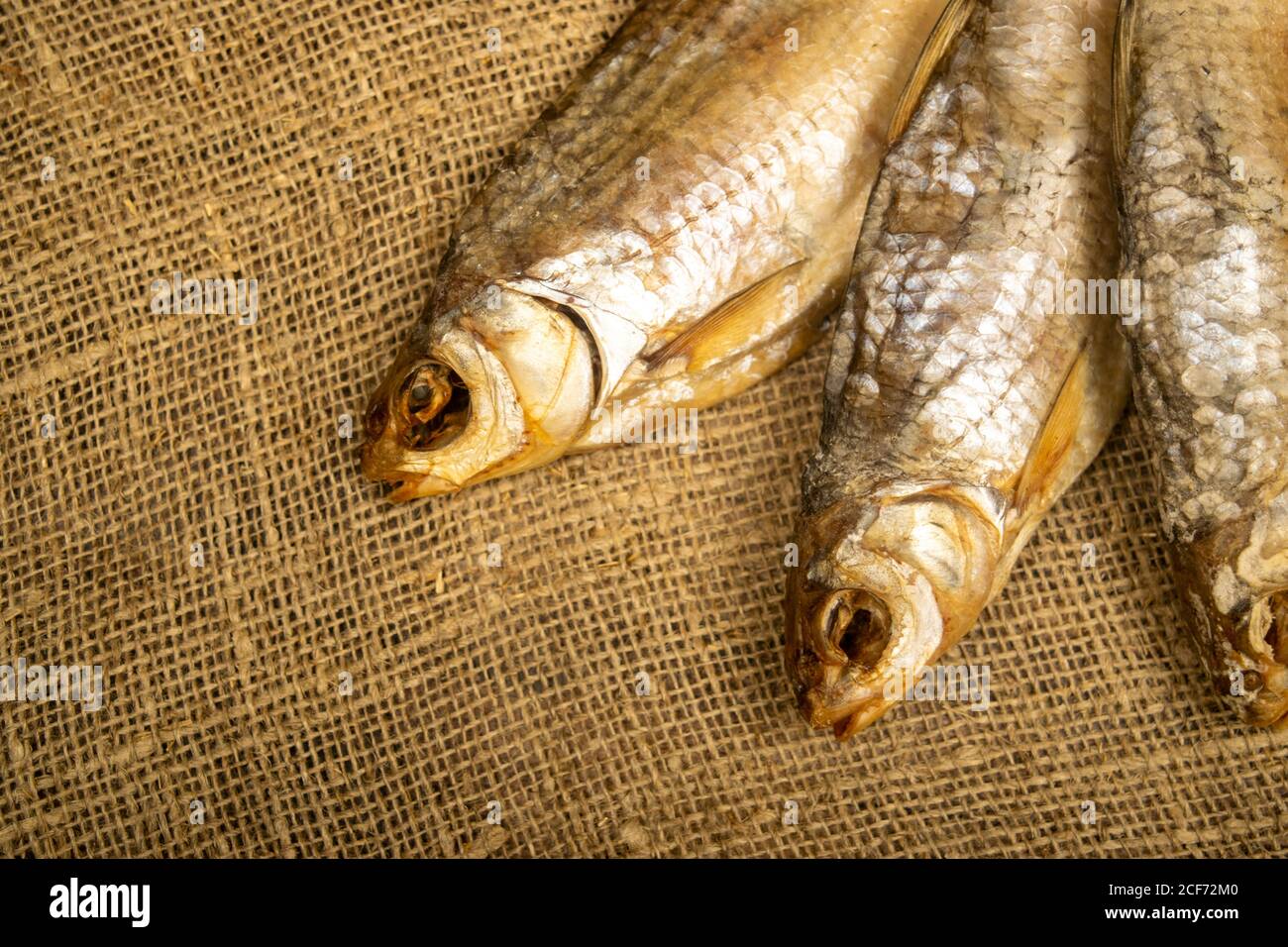 Dried fish on a homespun fabric with a rough texture. Close up Stock ...