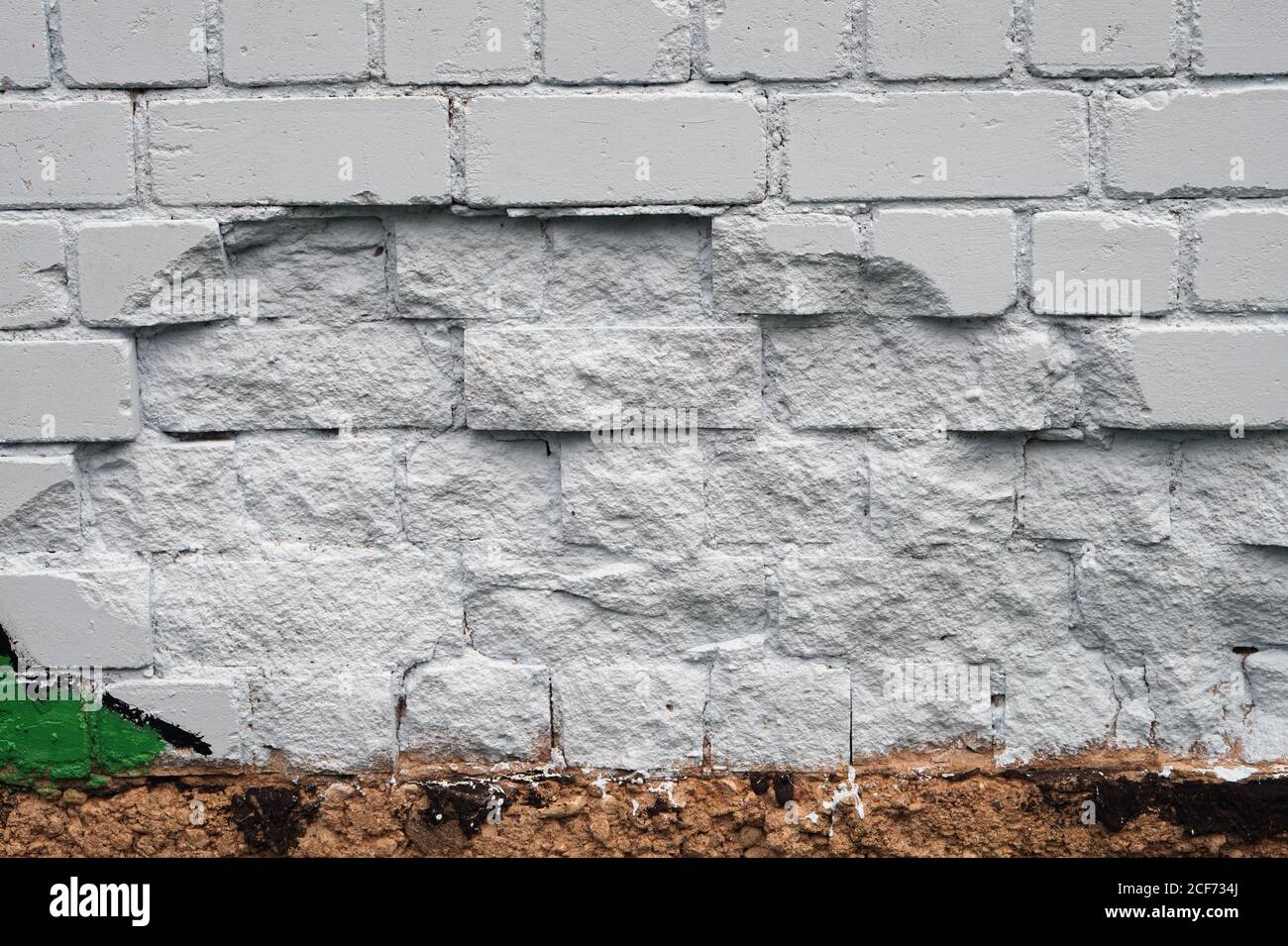 Brick wall defect painted over with white paint Stock Photo - Alamy