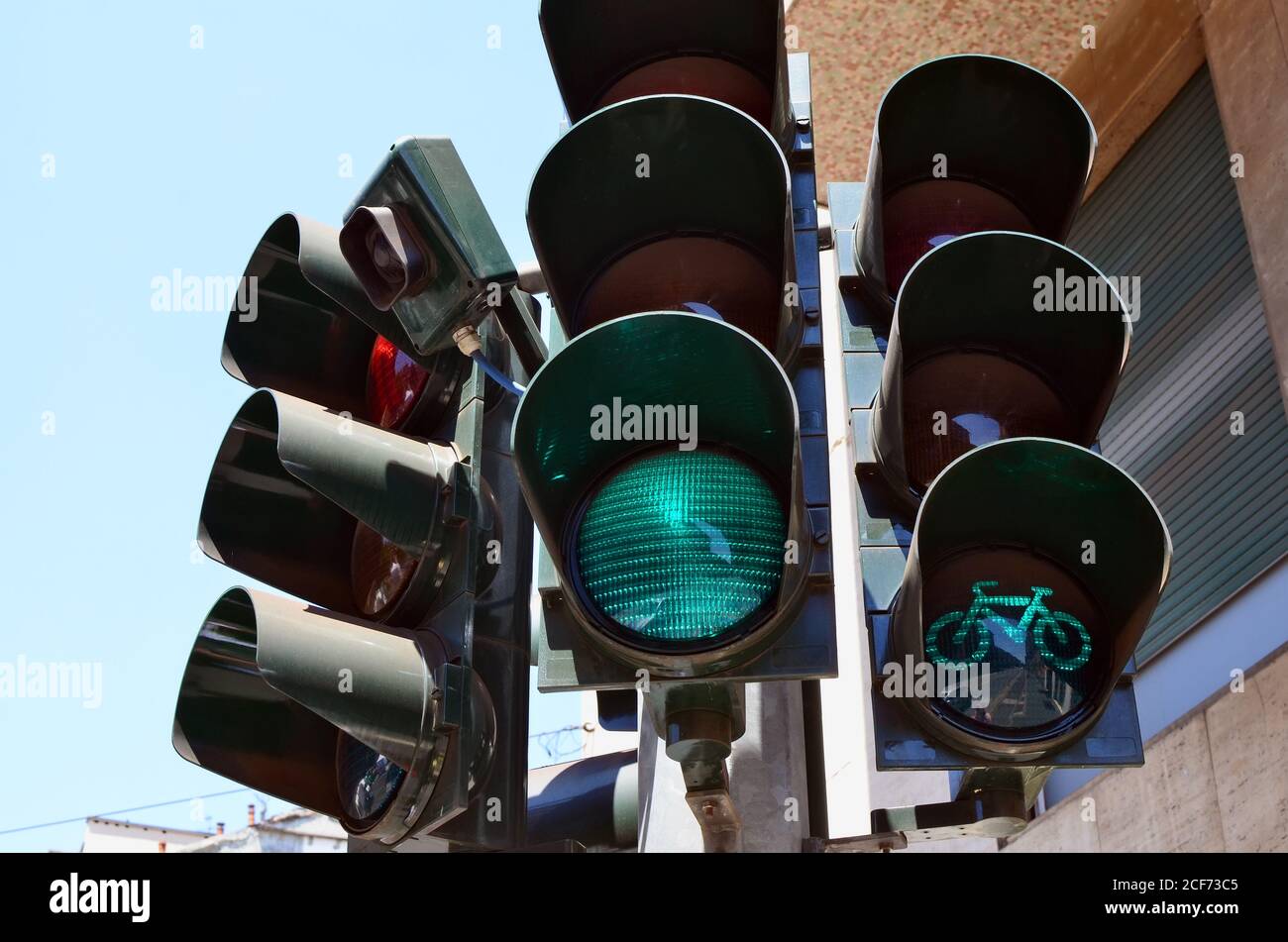 A green permissive light for pedestrians and bicycles shines at the ...
