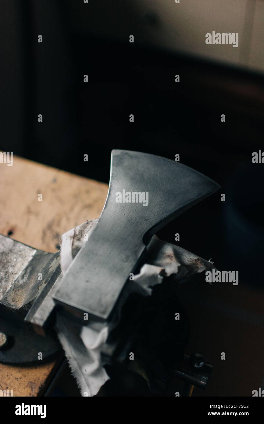 Sharp steel axe on table in workshop Stock Photo - Alamy