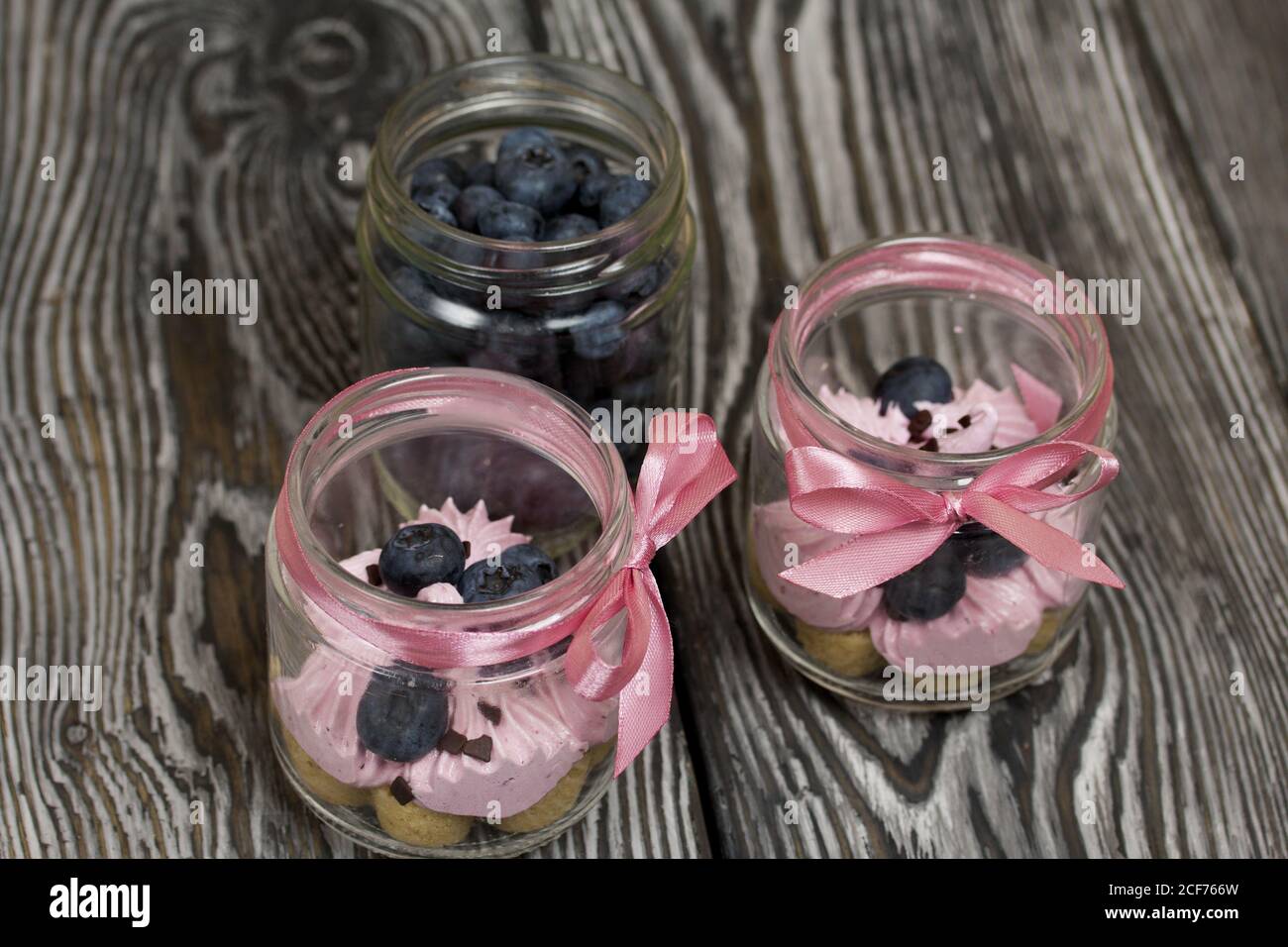 Zephyr in a jar, decorated with blueberries. On painted pine planks ...