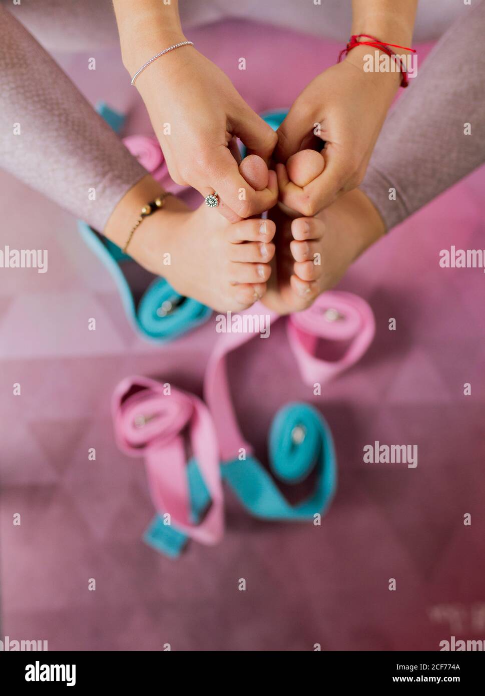 Decorated feet and hands of flexible Woman doing yoga pose in front of ...