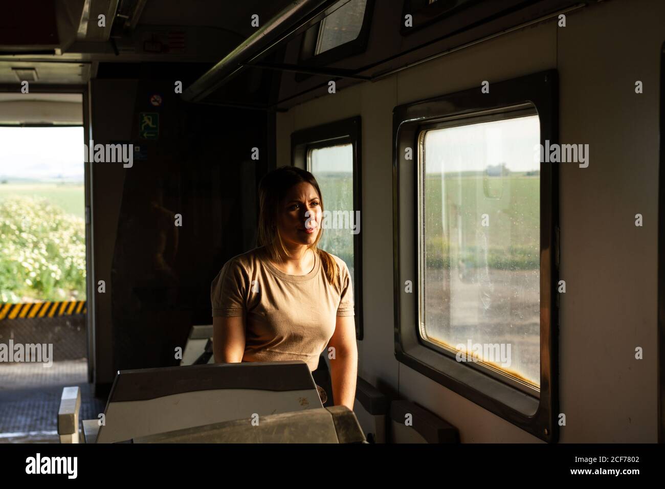Female soldier looking out window while travelling through countryside ...