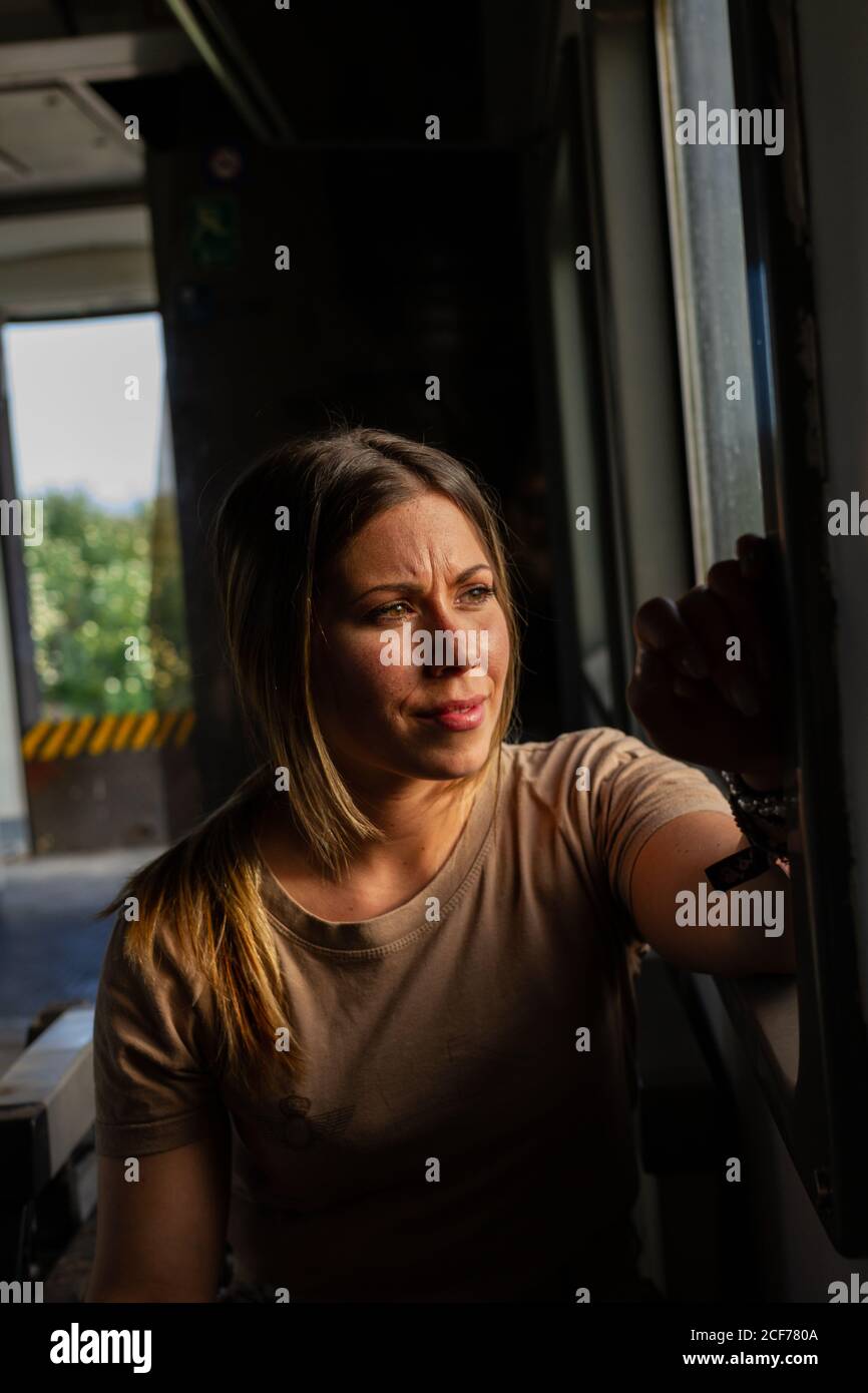 Female soldier looking out window while travelling through countryside ...