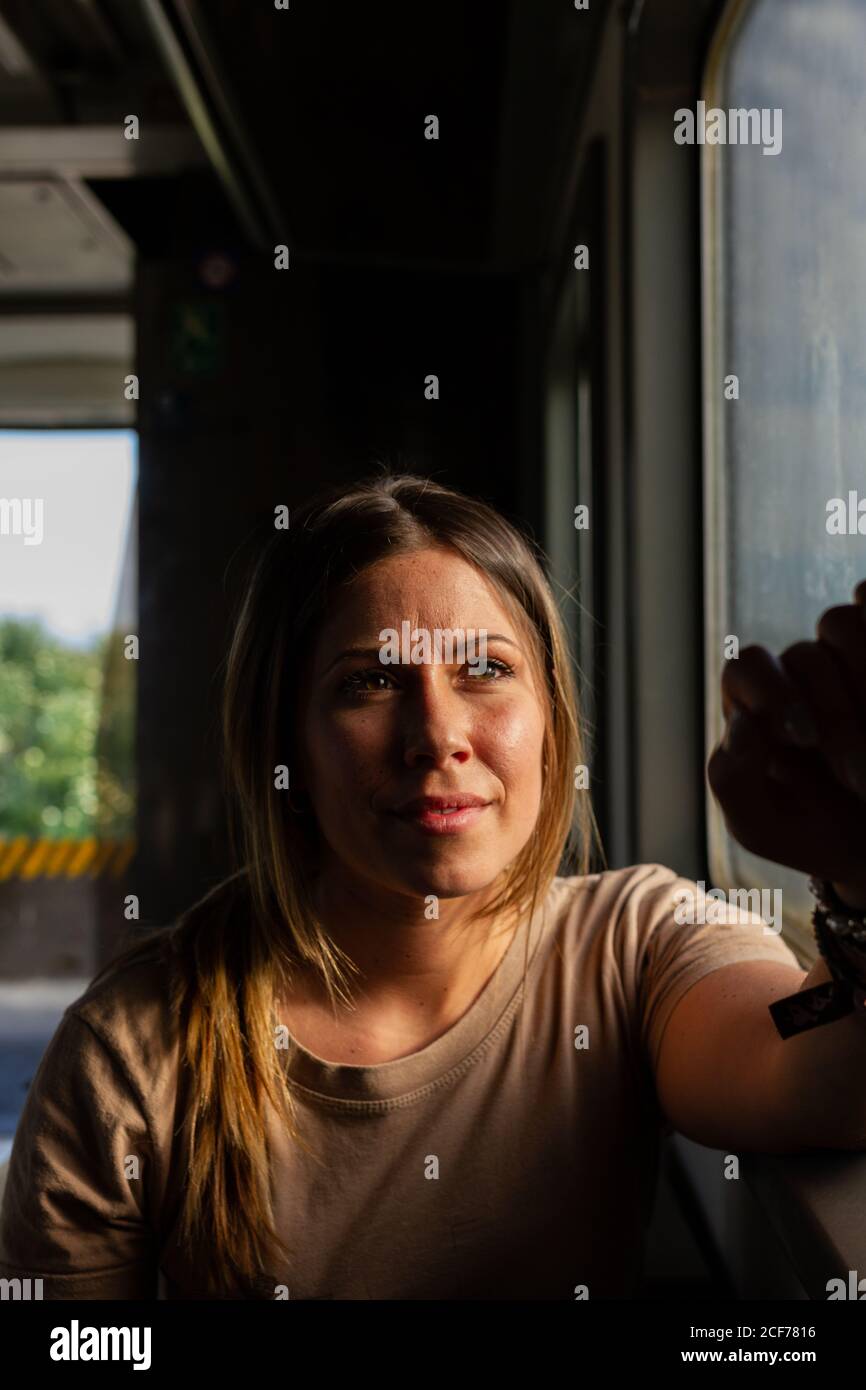 Female soldier looking out window while travelling through countryside ...