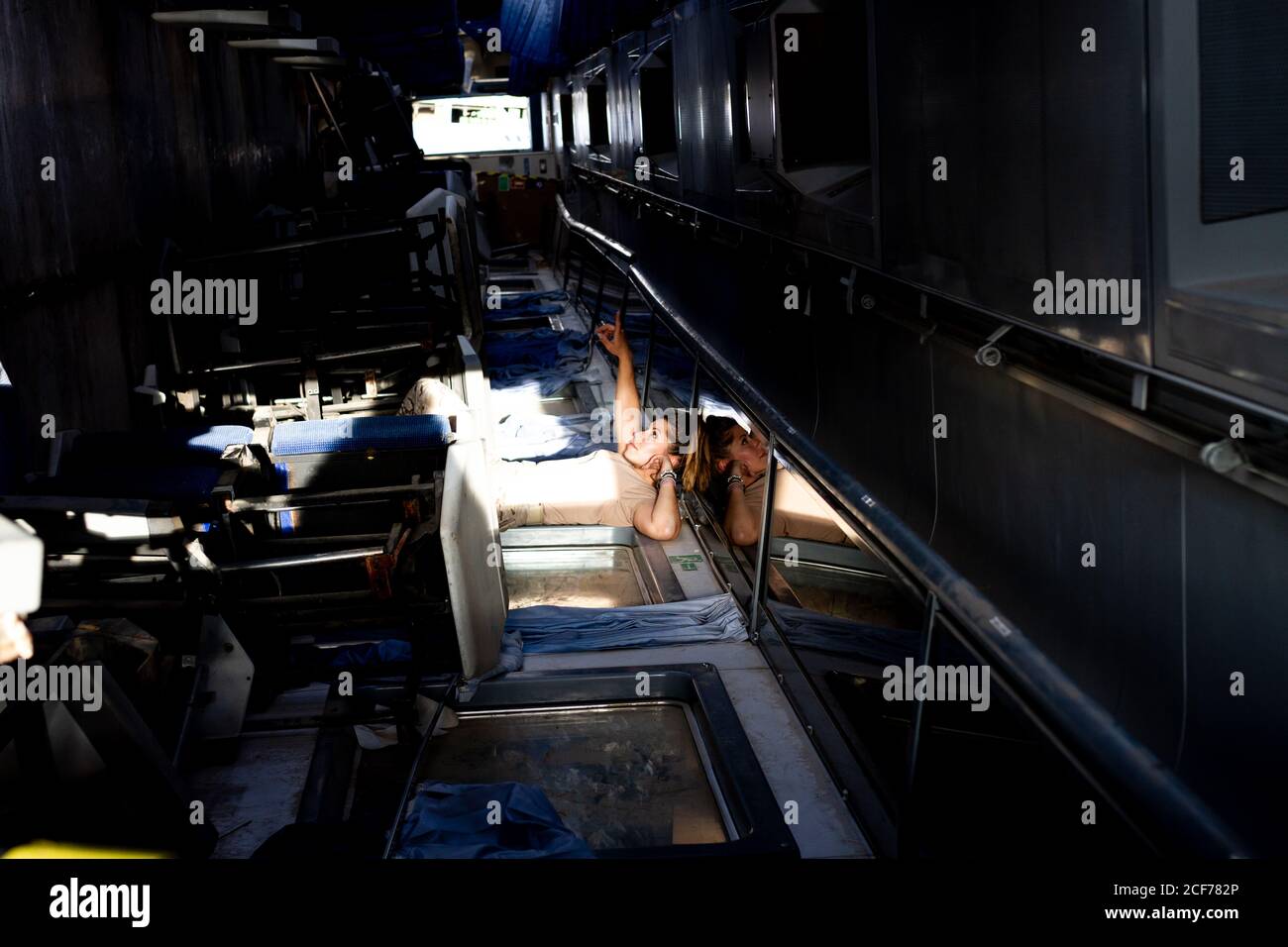 Side view of strong female soldier pointing up while looking at sky ...