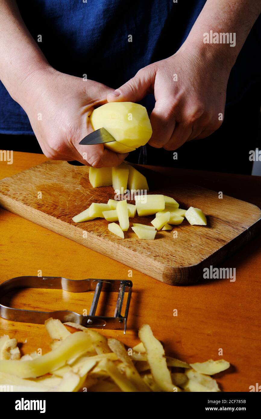 Crop anonymous cook peeling hi-res stock photography and images - Alamy