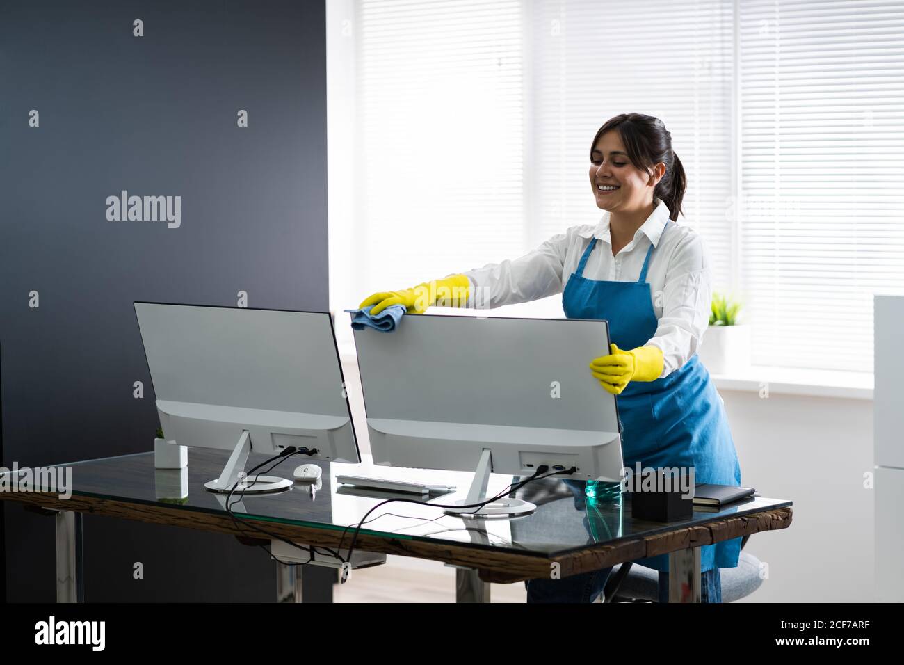 Woman Cleaning Office Desk And Computer Monitor. Professional Service ...