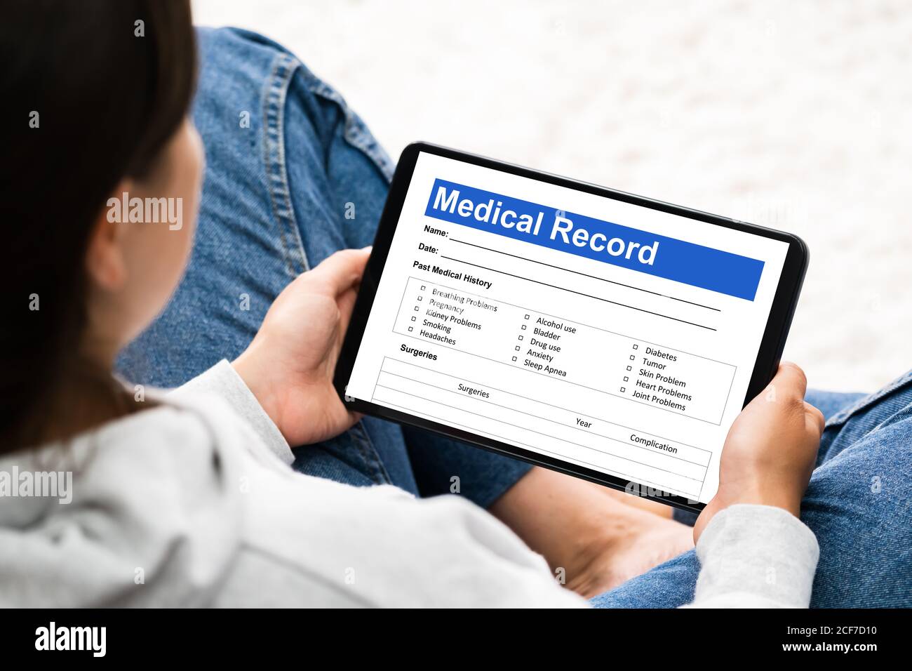 Woman Patient Using Hospital Record And Online Register Stock Photo - Alamy