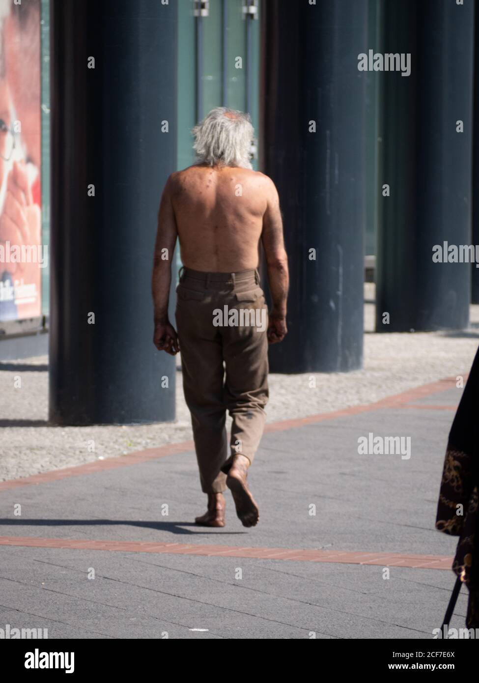 Vertical shot of a poor old man walking alone in the street Stock Photo ...