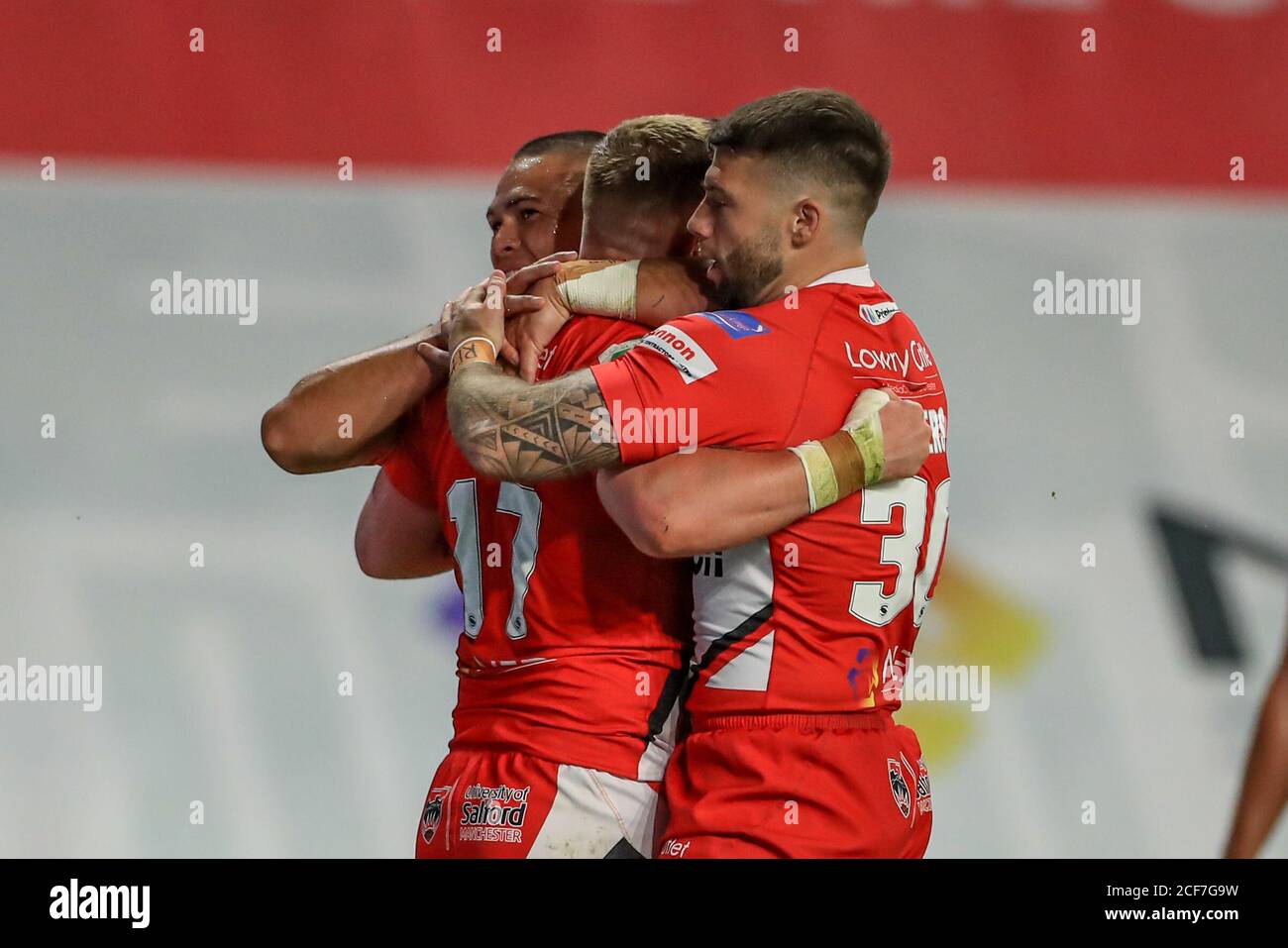 Luke Yates of Salford Red Devils celebrates his try with team mates ...