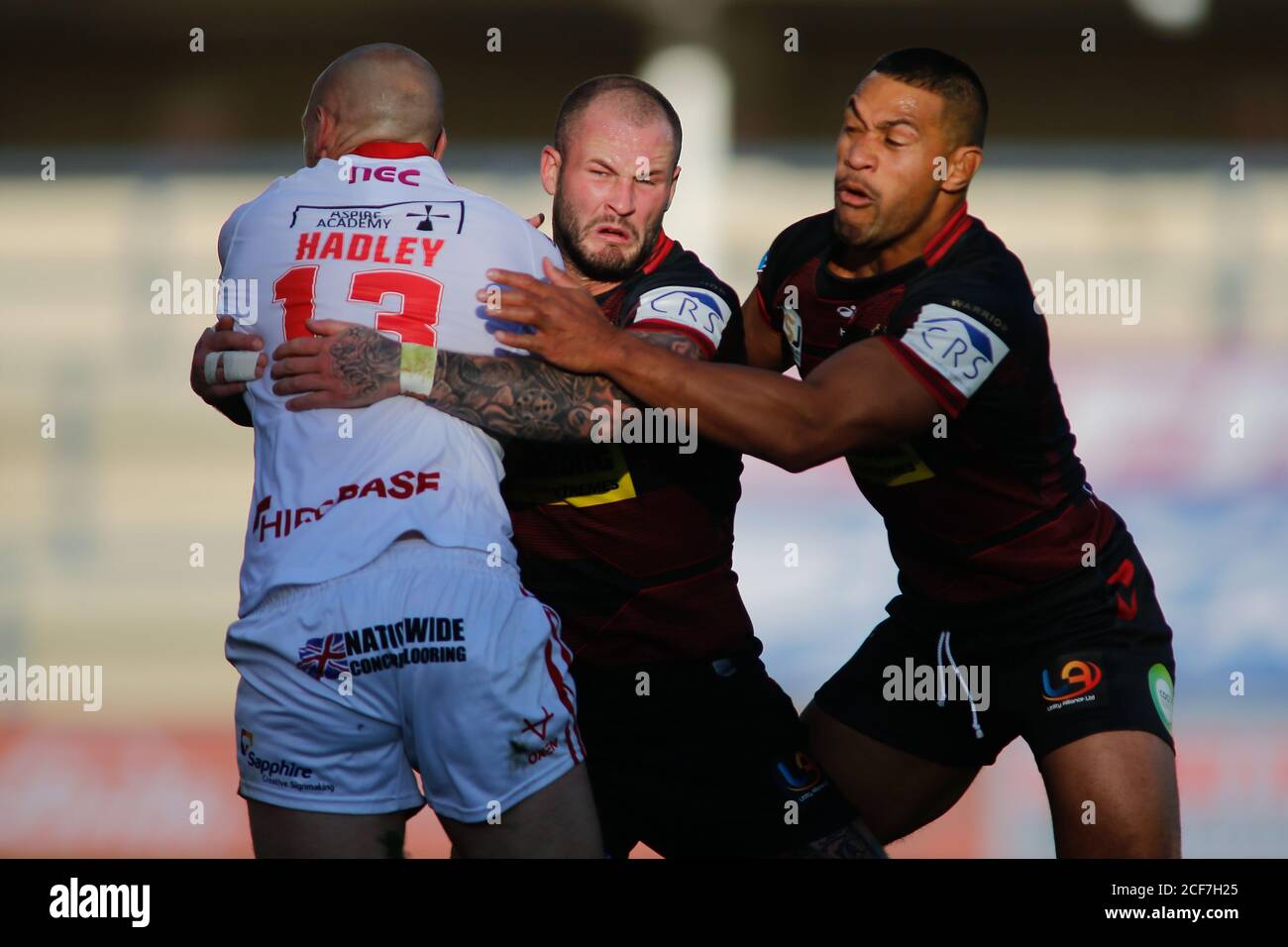 Dean Hadley (13) of Hull KR tackled by Zak Hardaker (1) and Willie Isa ...