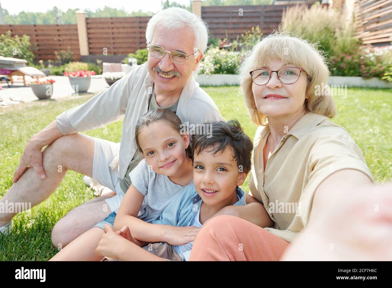 Modern grandma taking selfie shot of herself, her husband and ...
