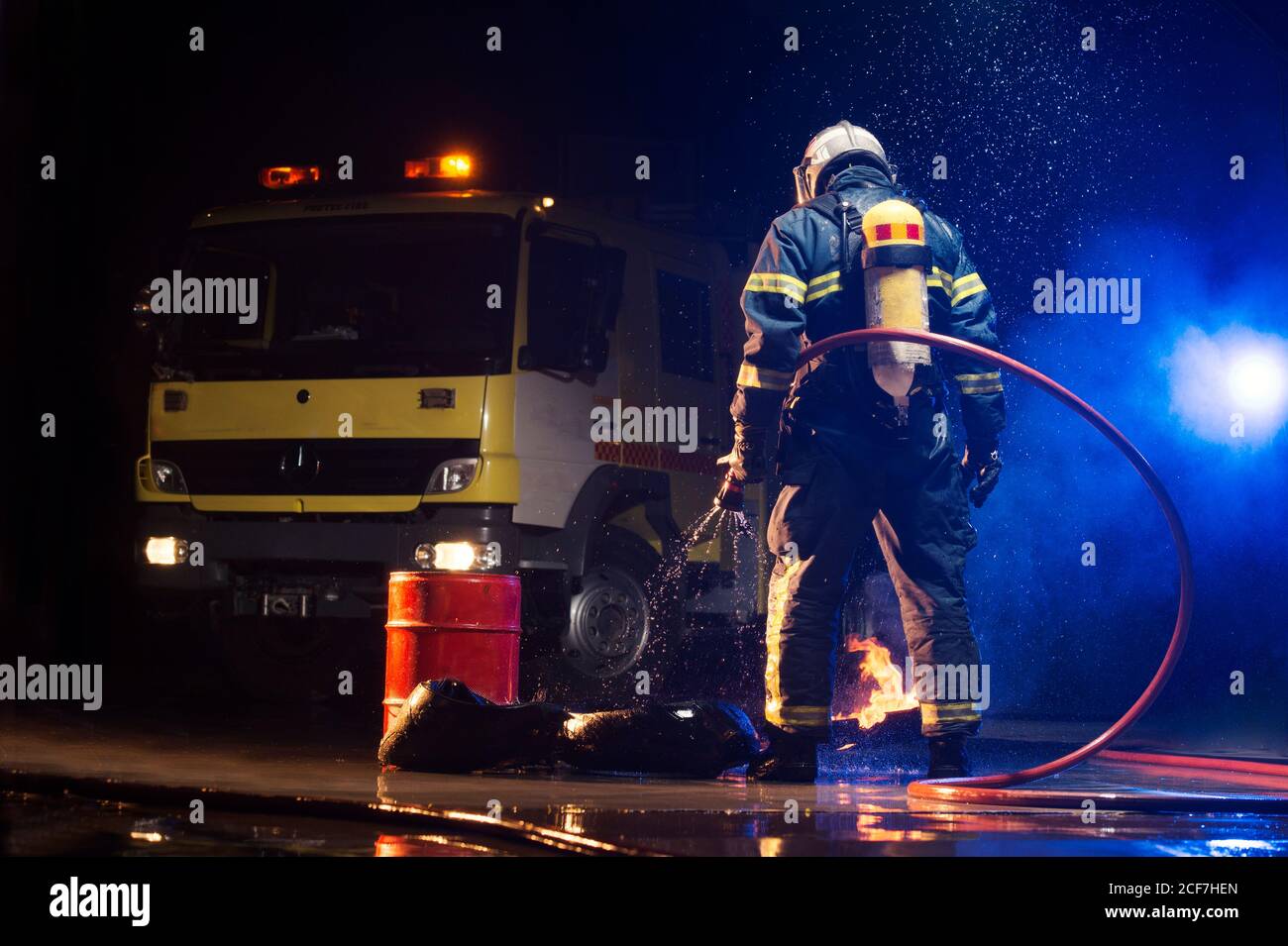 Firefighter using extinguisher water hi-res stock photography and ...