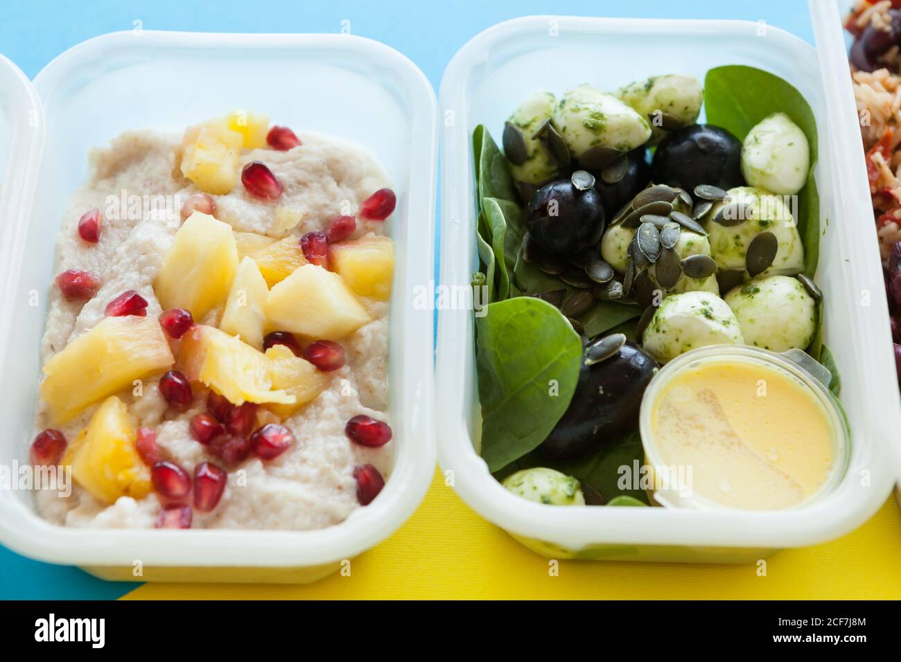 Container with healthy lunch over yellow and blue background. Take away ...