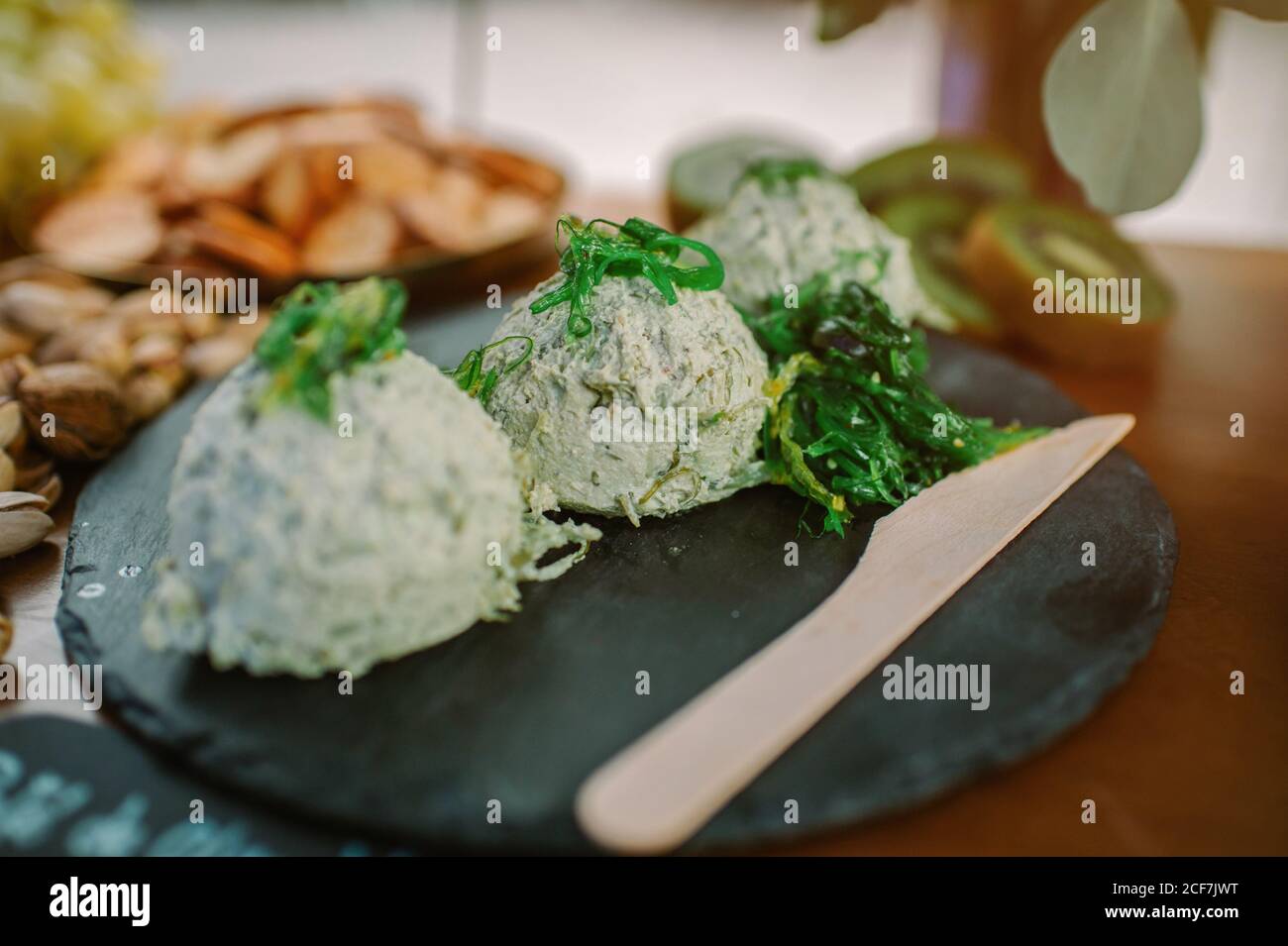 Palatable dish made of cottage cheese garnished with green seaweed and ...