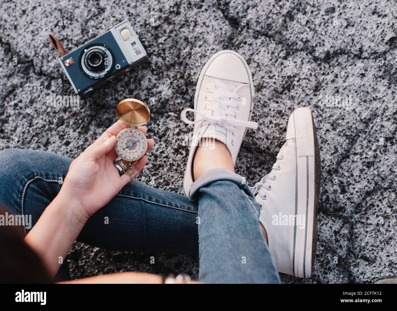 From above open compass in hands of crop creative Woman with photo ...