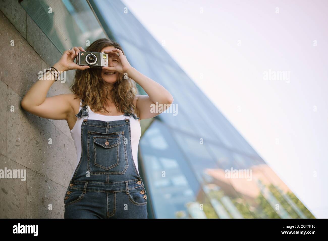 Young enthusiastic Woman capturing moment taking picture on camera on ...