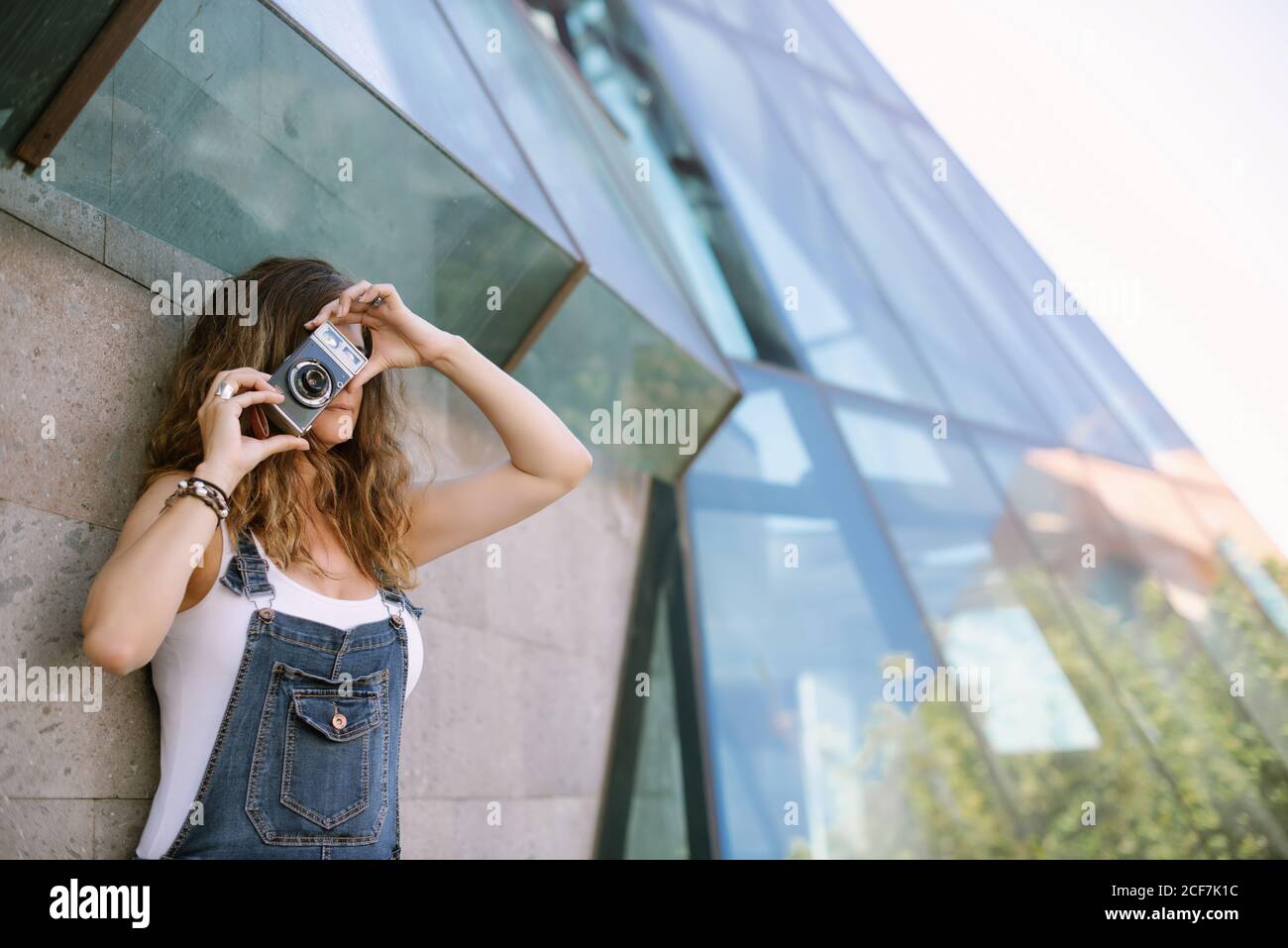 Young enthusiastic Woman capturing moment taking picture on camera on ...