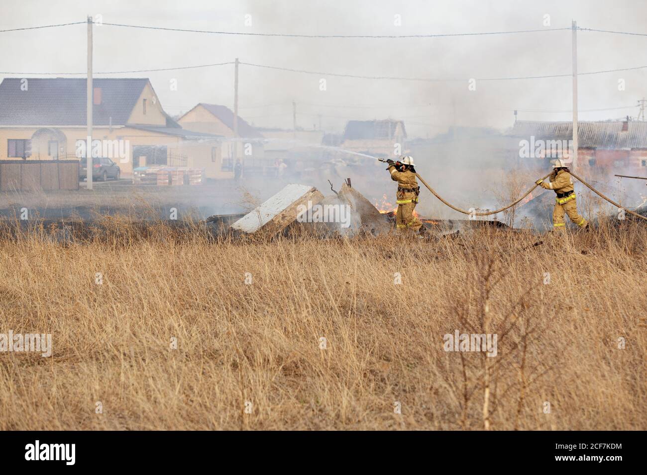 Firemen using hose hi-res stock photography and images - Alamy