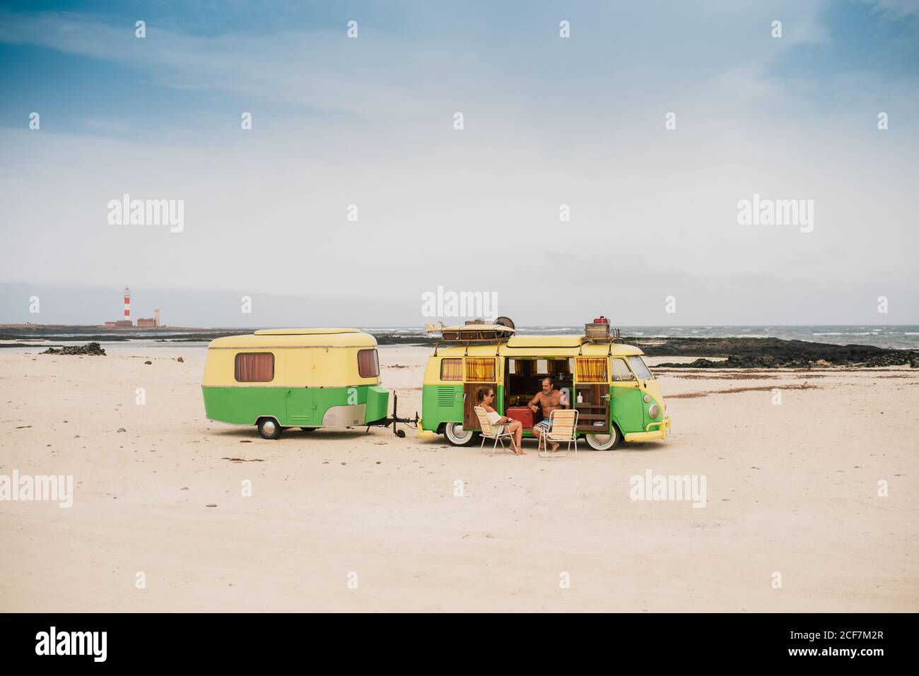 Friends in minibus with trailer on beach Stock Photo - Alamy