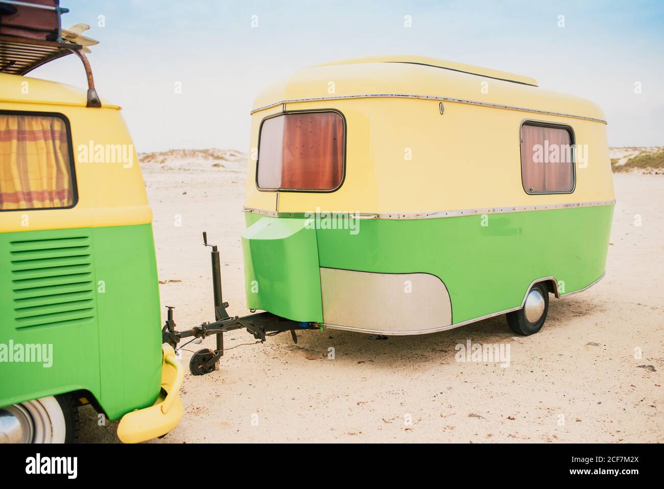 Colorful minibus with trailer parked on sandy shore in sunny day Stock ...