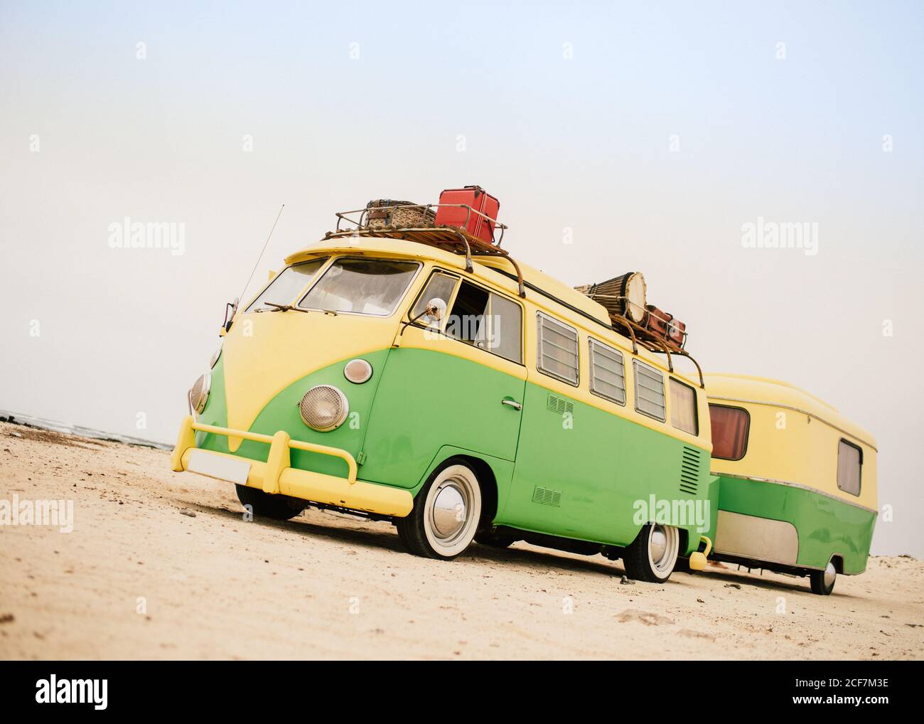 Colorful minibus with trailer parked on sandy shore in sunny day Stock ...
