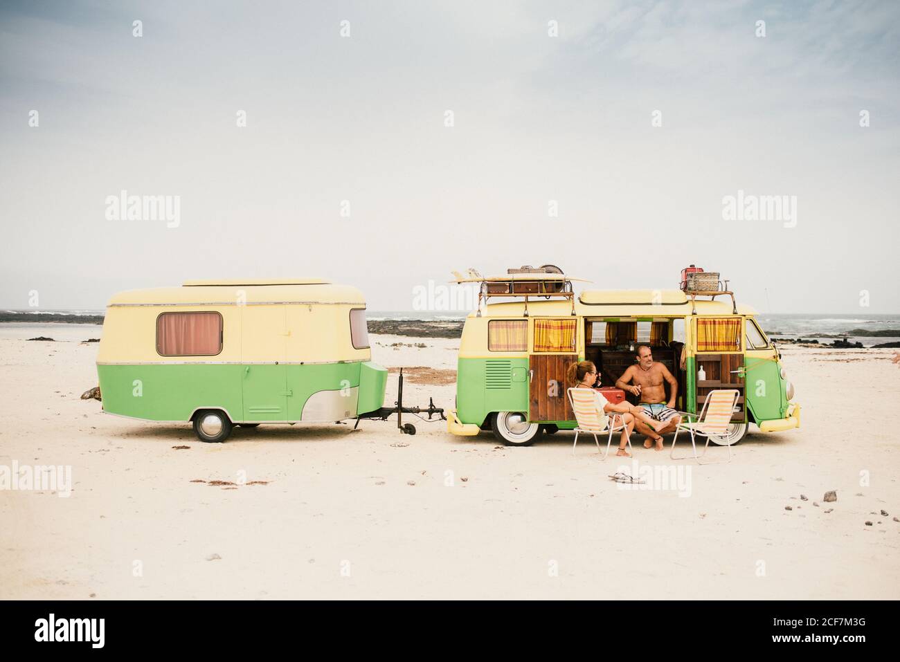 Friends in minibus with trailer on beach Stock Photo - Alamy