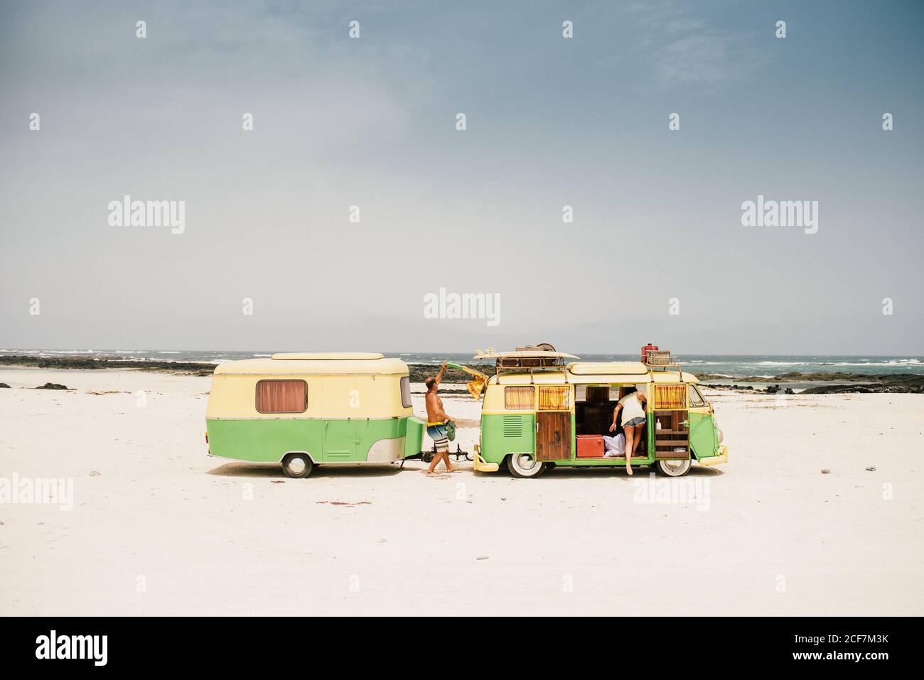 Friends in minibus with trailer on beach Stock Photo - Alamy