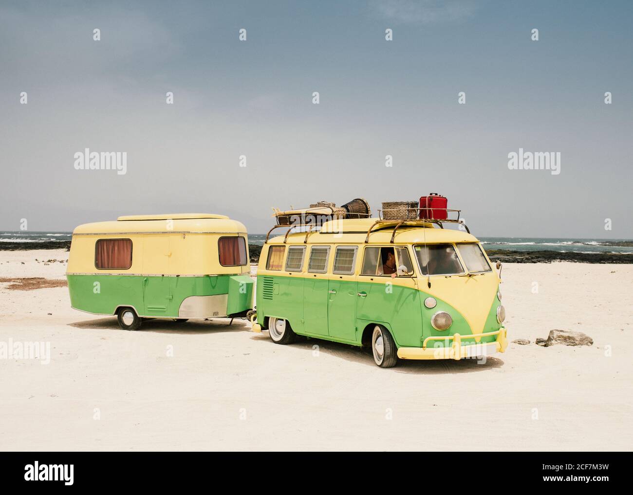 Shiny and clear minibus of green and yellow colors with trailer ...