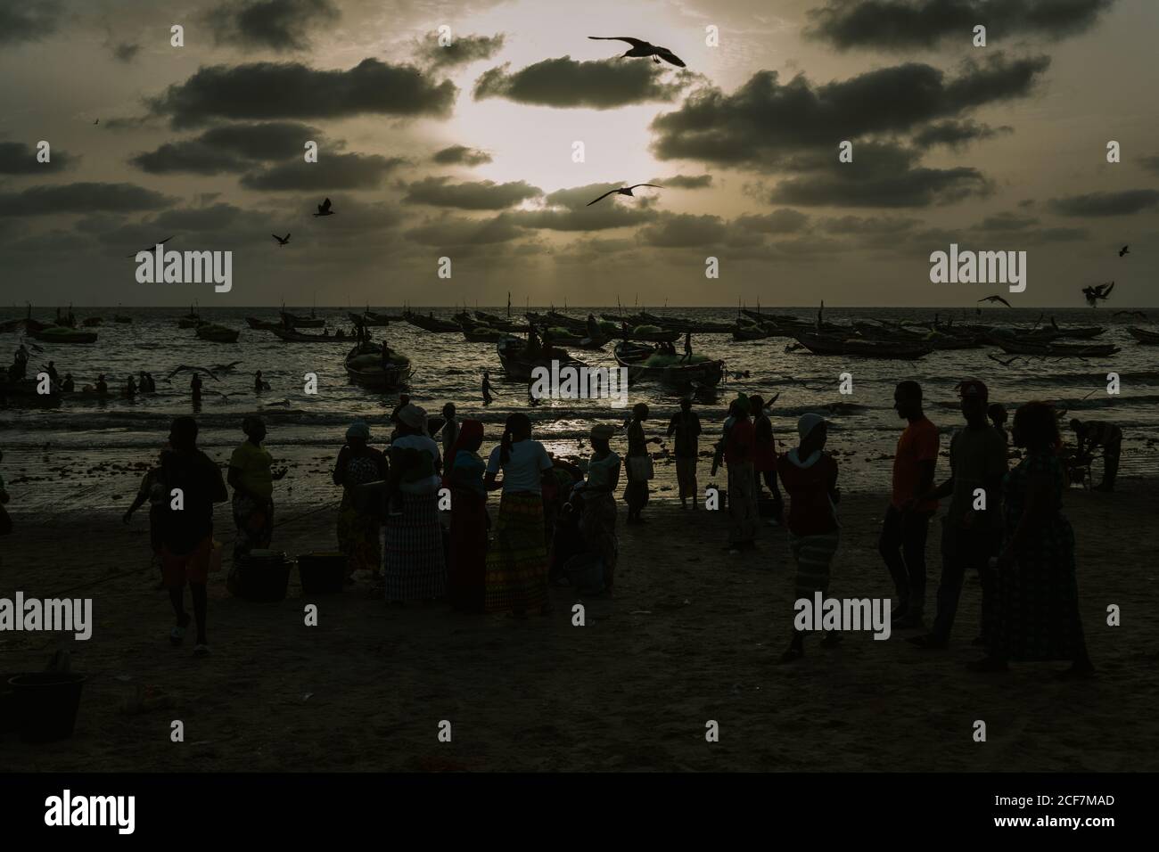 Gambia, Africa - August 3, 2019: Crowd of people standing on beach in ...