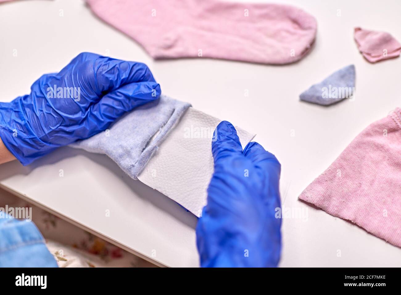 faceless person in blue sterile gloves putting white napkin inside of ...