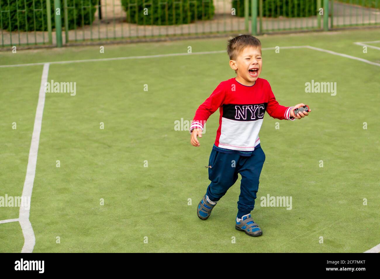 POZNAN, POLAND - Aug 26, 2020: Small crying boy walking on a green ...
