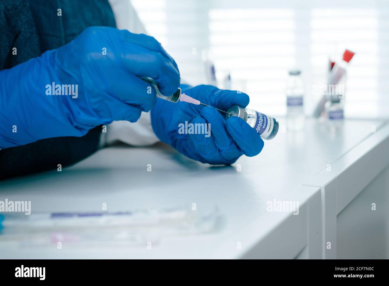 Nurse filling syringe with vaccine liquid Stock Photo - Alamy