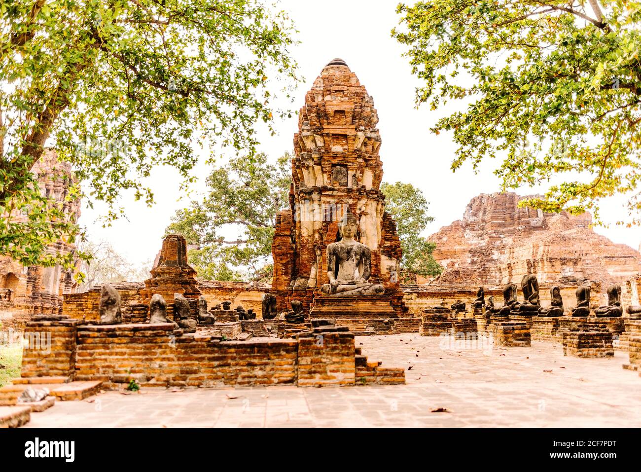 Ancient stone statue of Buddha in lotus pose with massive monument ...