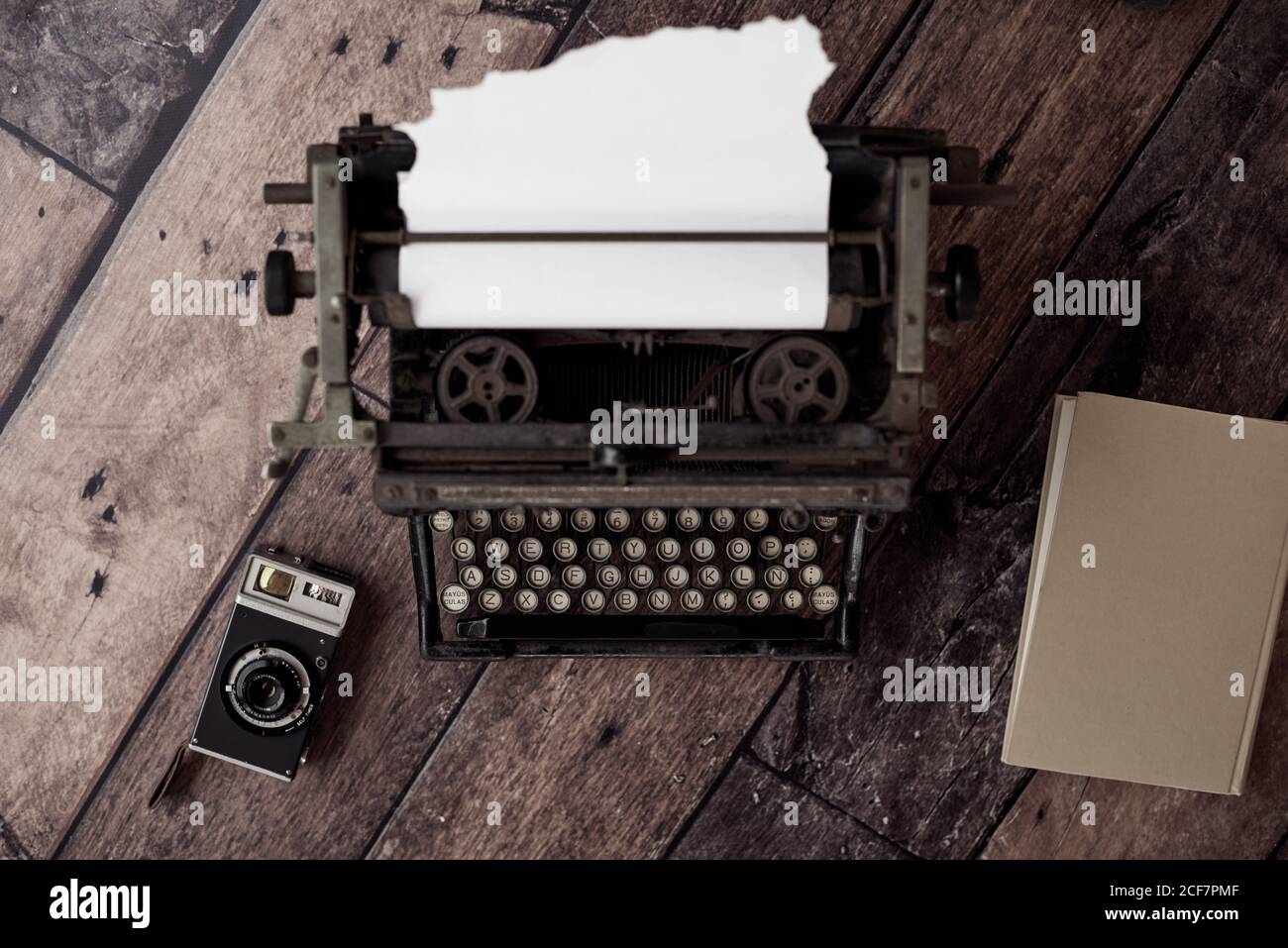 From above of old fashioned typewriter with paper placed on table with ...
