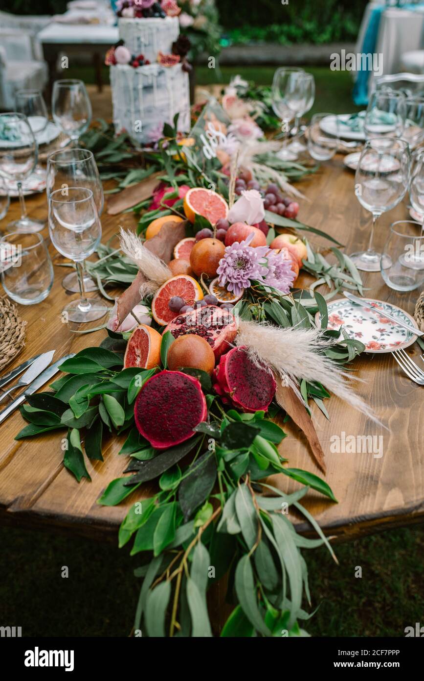 Beautiful garland made from ripe cut tropical fruits and green branches ...