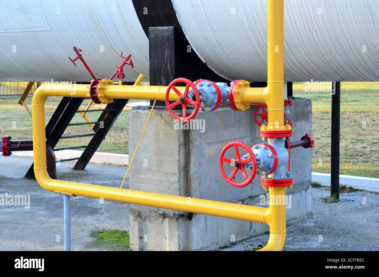 Industrial piping with steel flanges and bolts on oil field. Fuel pipes ...