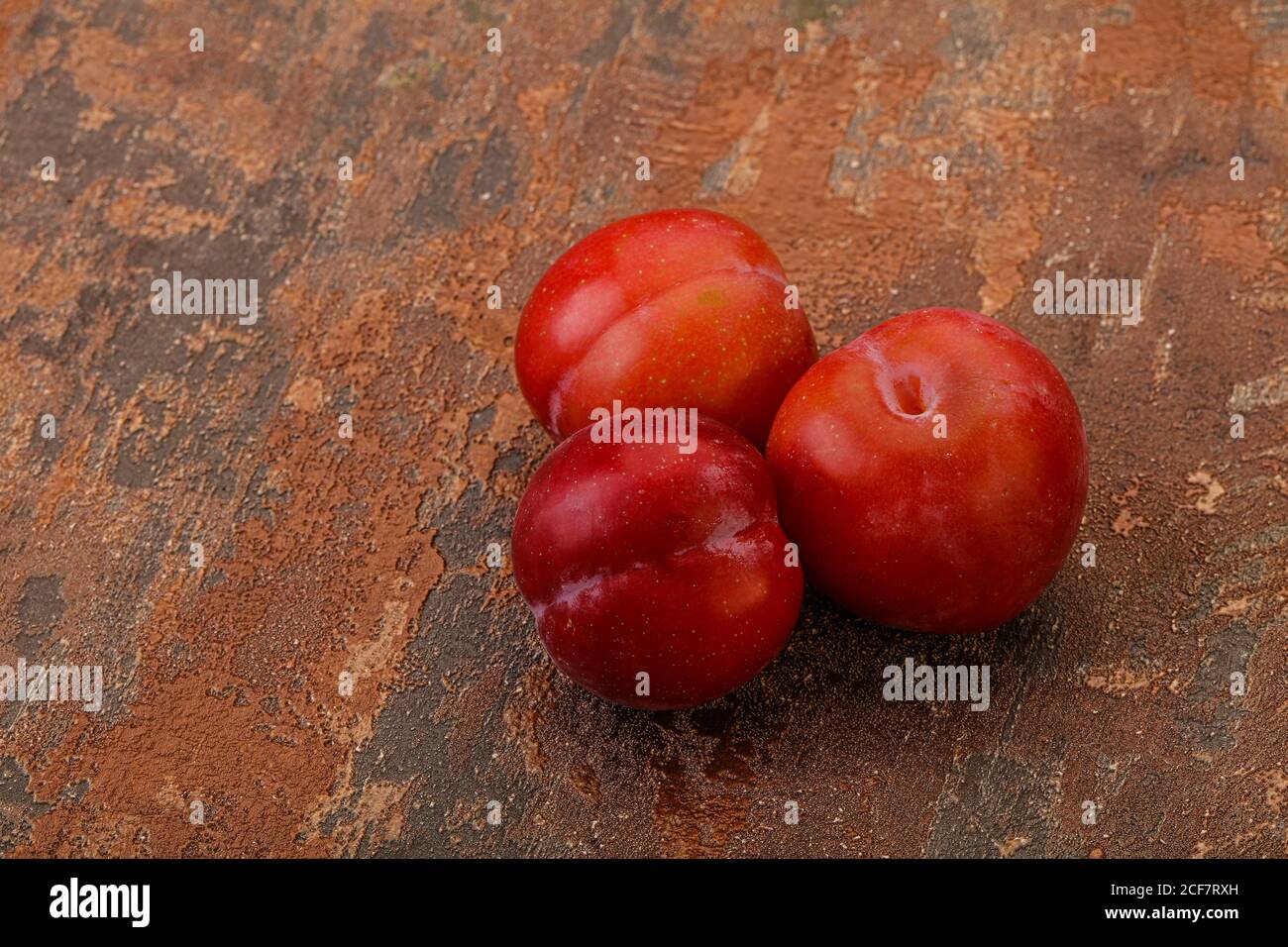 Ripe sweet tasty red plum heap Stock Photo - Alamy