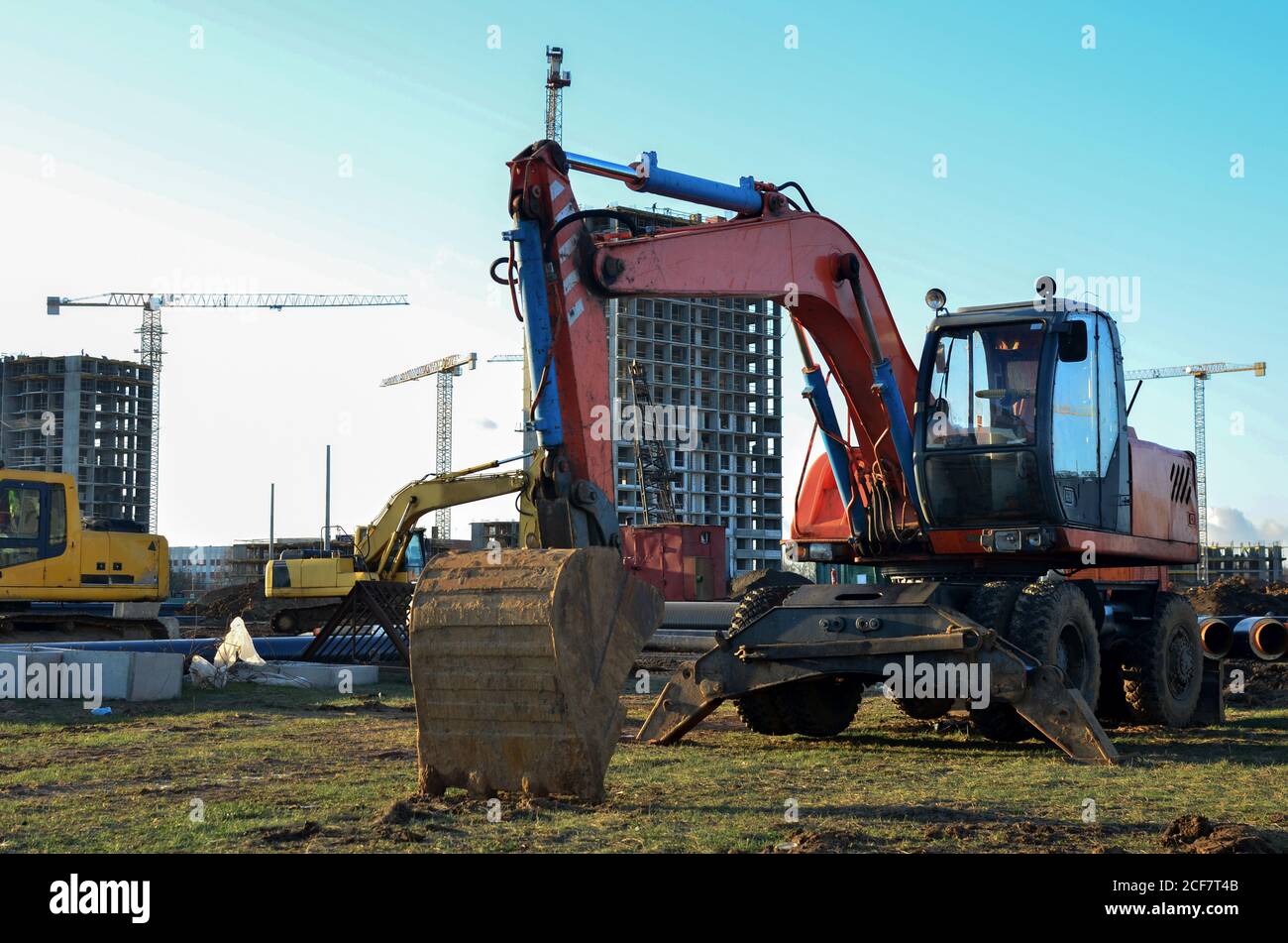 Excavator with a large iron bucket on a construction site during road ...