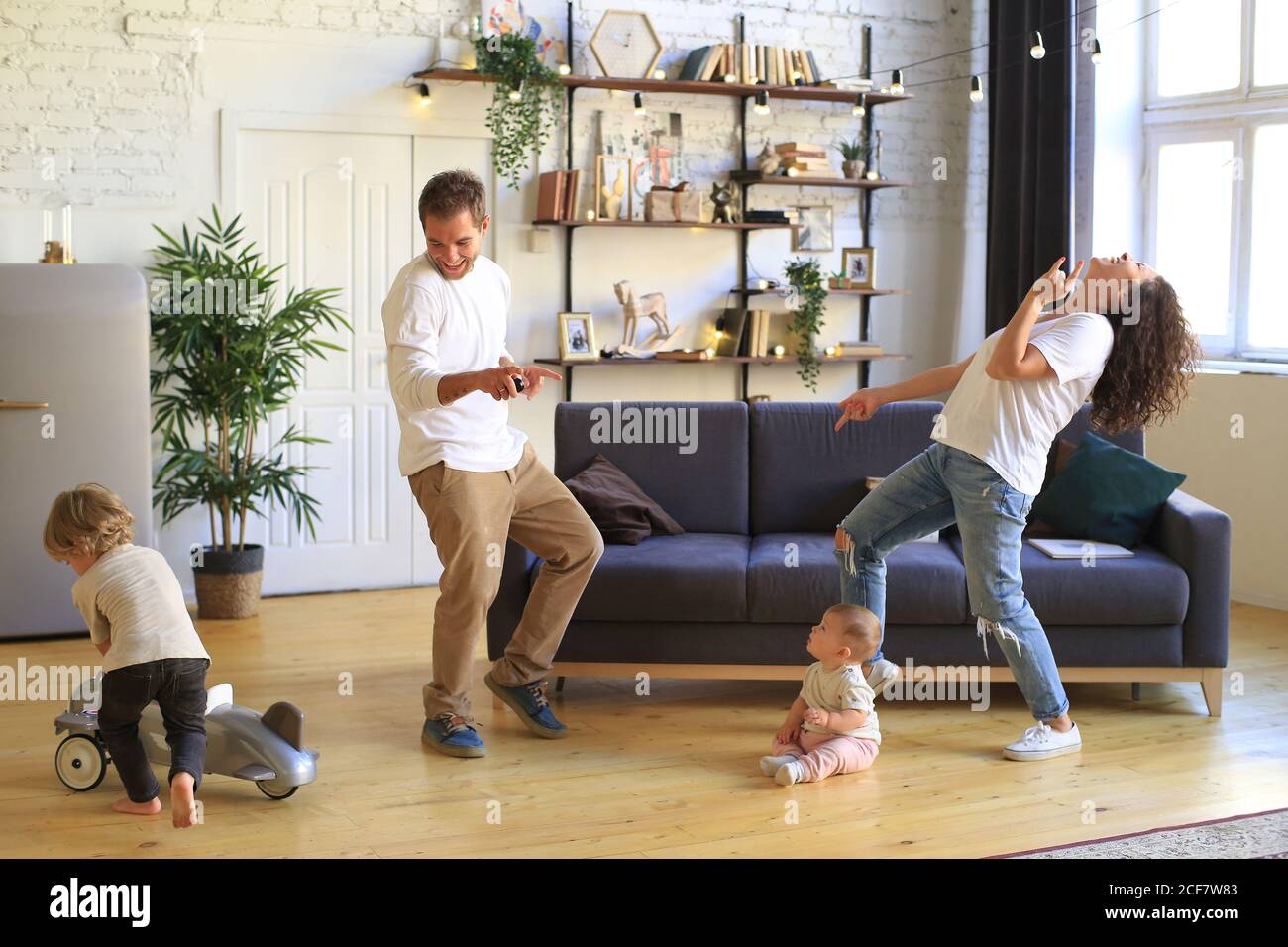 Young beautiful happy family relaxing at home Stock Photo - Alamy