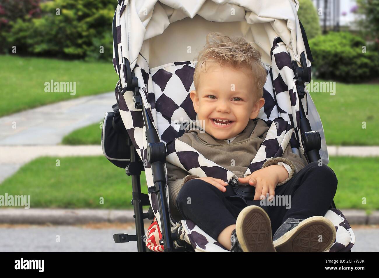 Little beautiful boy in a stroller on the street Stock Photo - Alamy