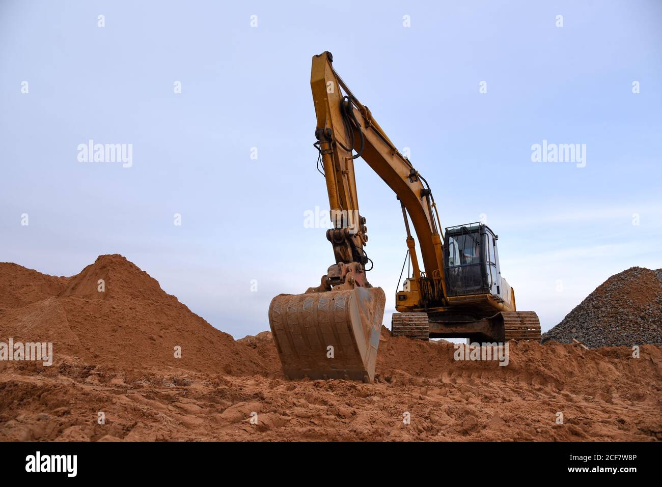 Track-type excavator during earthmoving works at open-pit mining ...