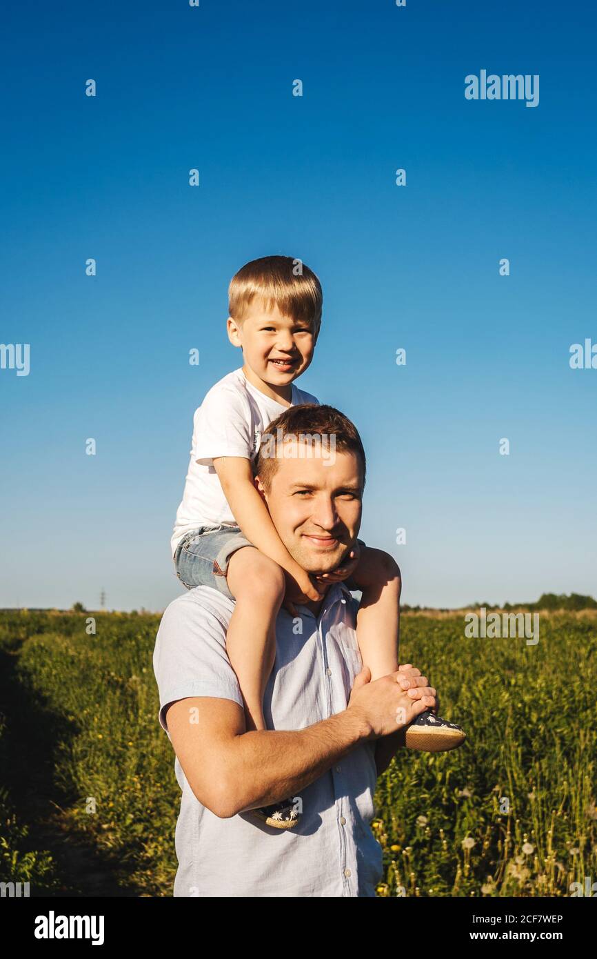 Son riding on fathers shoulders hi-res stock photography and images - Alamy
