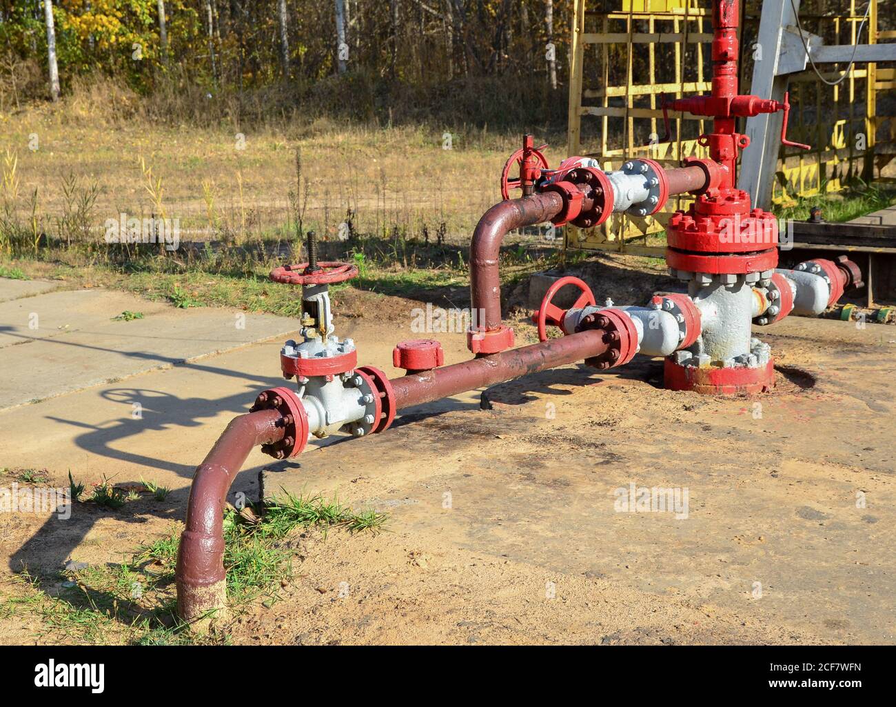 Industrial piping with steel flanges and bolts on oil field. Fuel pipes ...