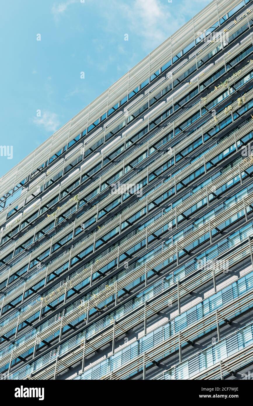 Modern tall building with a glass and metal facade Stock Photo - Alamy